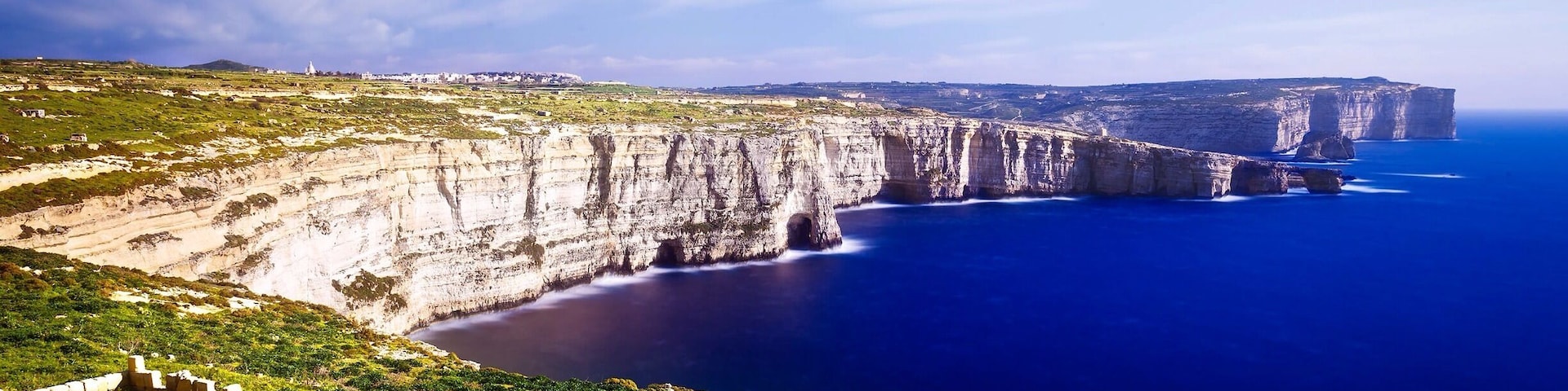 There's something magical about the place where land and ocean meet. It can be a tranquil spot suited for relaxing and perhaps taking a swim or a violent battlefront where the water seems intent on swallowing everything in its path. Since Malta is an island (or actually several islands) there are endless places where you can see and enjoy this for yourself.
This photo is taken on a peninsula far to the northwest on Gozo (see the map) from where you get a splendid view of some majestic cliffs and, in the distance, the famous arch called Azure Window.