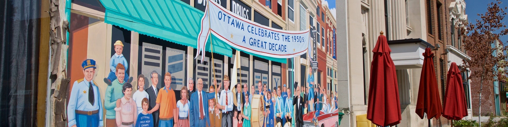 A mural on a building depicting a group of people in various outfits, with a banner reading "Ottawa Hula Hoop Champs" and "Ottawa Celebrates the 1950s."