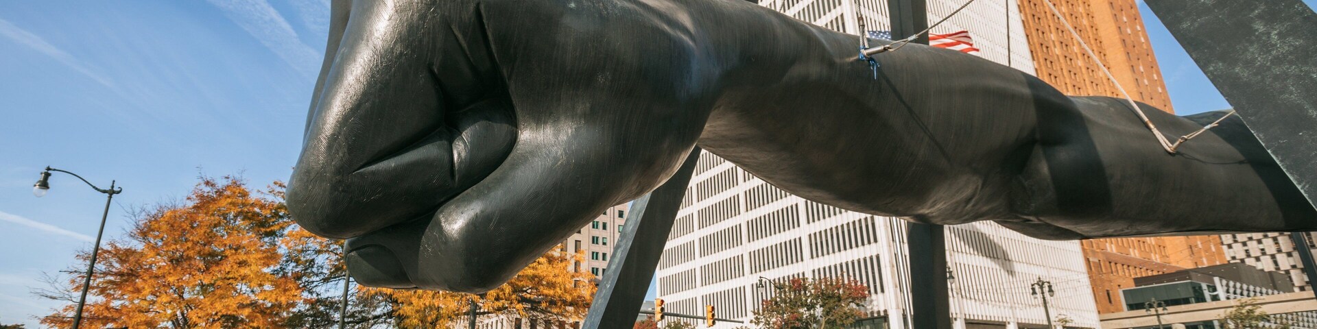 Downtown Detroit featuring outdoor art and a statue or sculpture