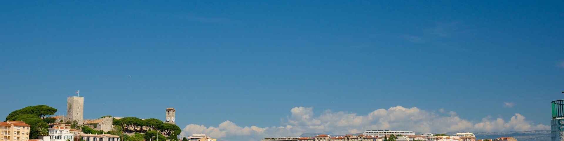 Cannes Harbour showing a small town or village and a bay or harbor