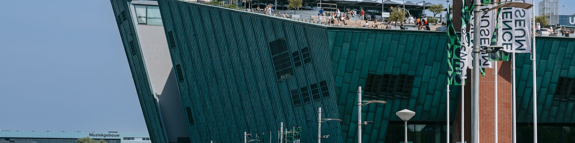 Nemo Science Museum featuring modern architecture and a bay or harbor