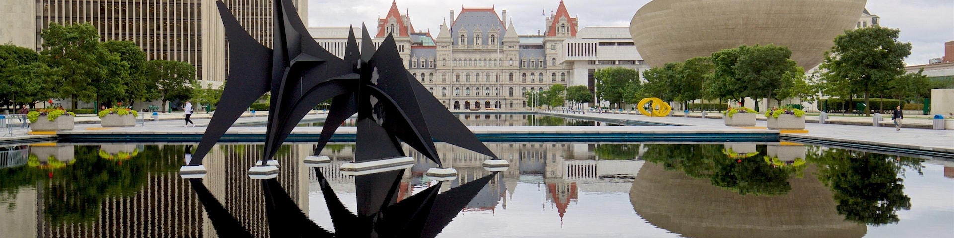 Governor Nelson A. Rockefeller Empire State Plaza showing outdoor art, a pond and modern architecture