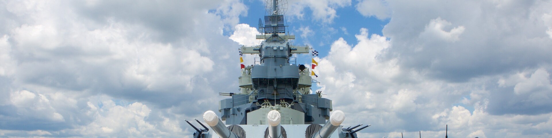 Battleship North Carolina featuring heritage elements as well as a small group of people