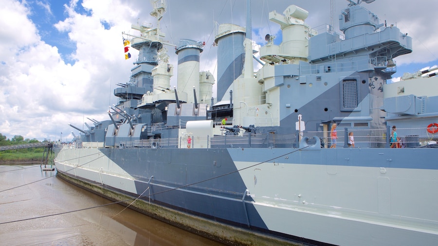 Battleship North Carolina featuring heritage elements as well as a small group of people