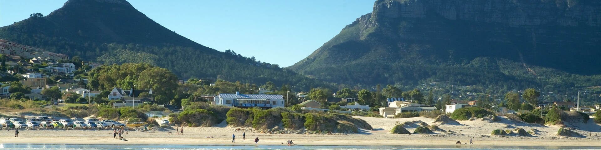 Hout Bay Beach showing a sandy beach and kayaking or canoeing as well as a couple
