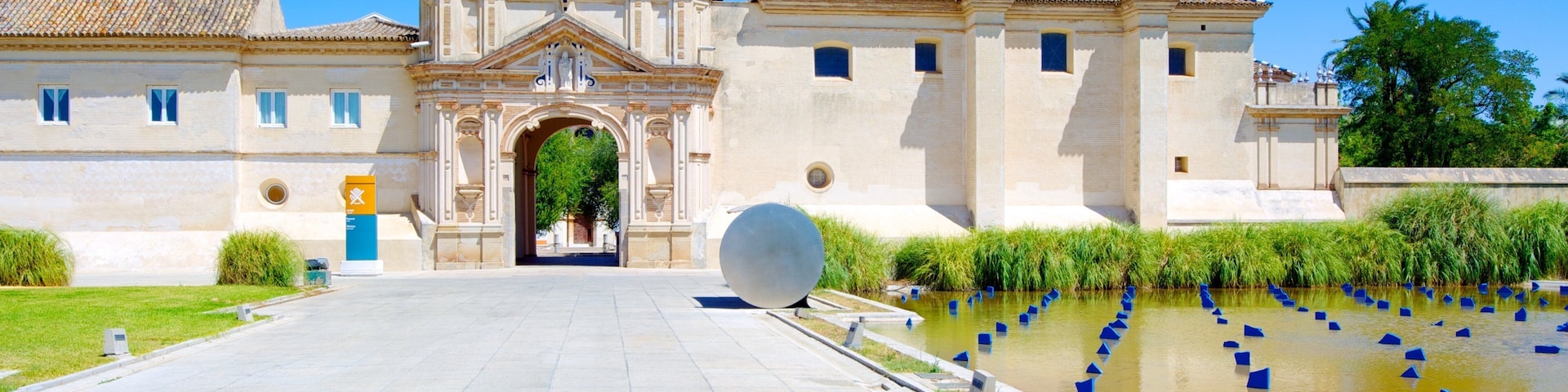 La Cartuja which includes a pond, a castle and heritage architecture