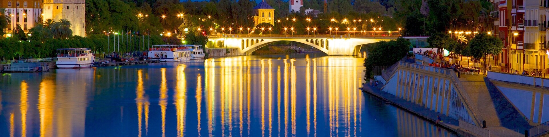 Triana Bridge which includes a marina, a river or creek and a bridge