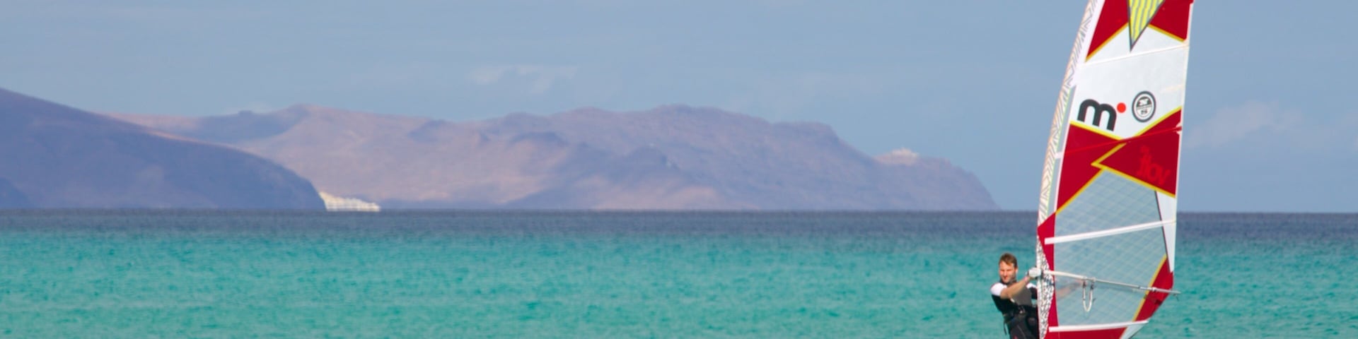 Sotavento de Jandia Beach featuring general coastal views and windsurfing as well as an individual male