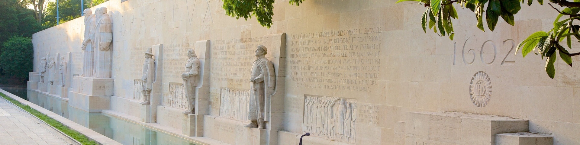Reformation Wall Monument which includes a monument, a pond and a statue or sculpture