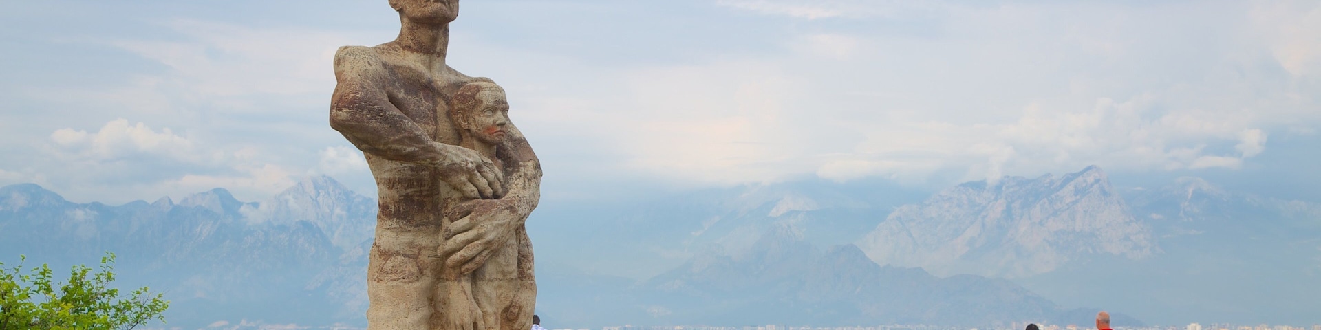 Karaalioglu Park which includes flowers, outdoor art and a statue or sculpture