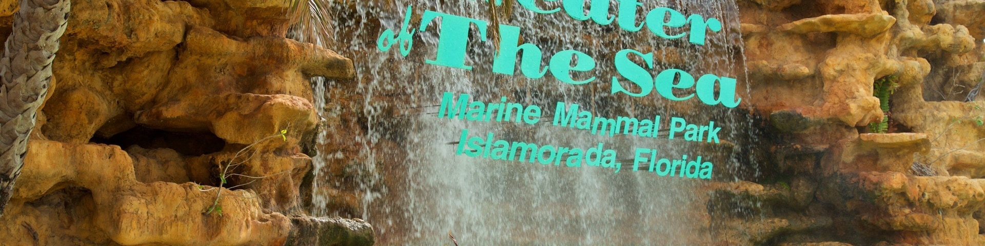 Theater of the Sea which includes a fountain and signage