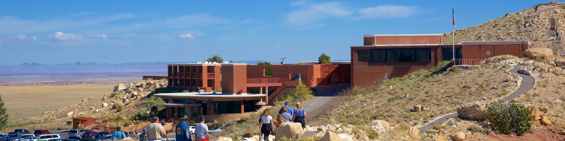 Meteor Crater featuring tranquil scenes and desert views as well as a small group of people