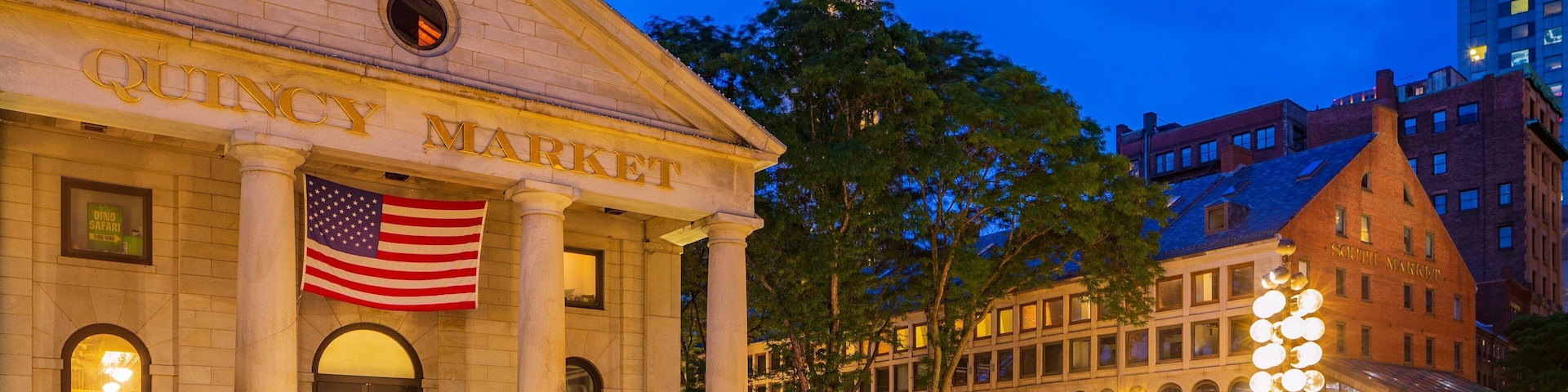 Faneuil Hall Marketplace which includes night scenes, heritage architecture and street scenes