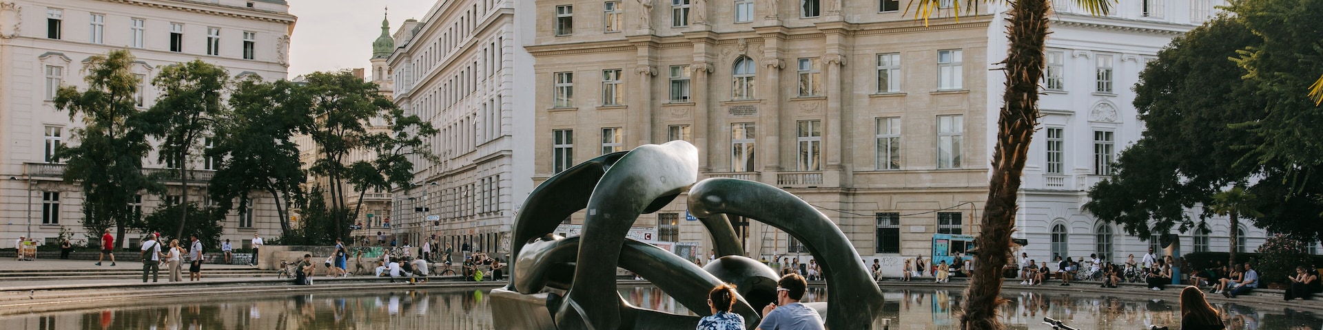 Karlsplatz showing a fountain and a sunset as well as a couple