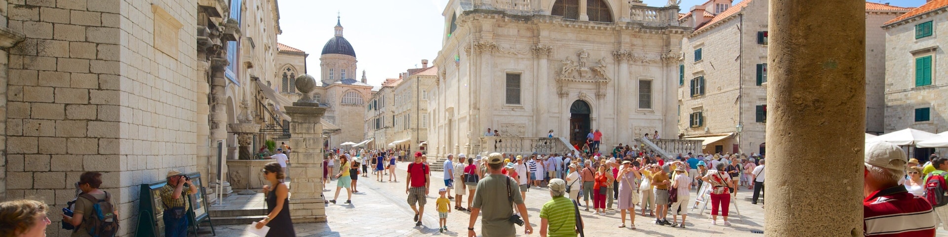 Sponza Palace which includes a square or plaza and heritage architecture as well as a large group of people