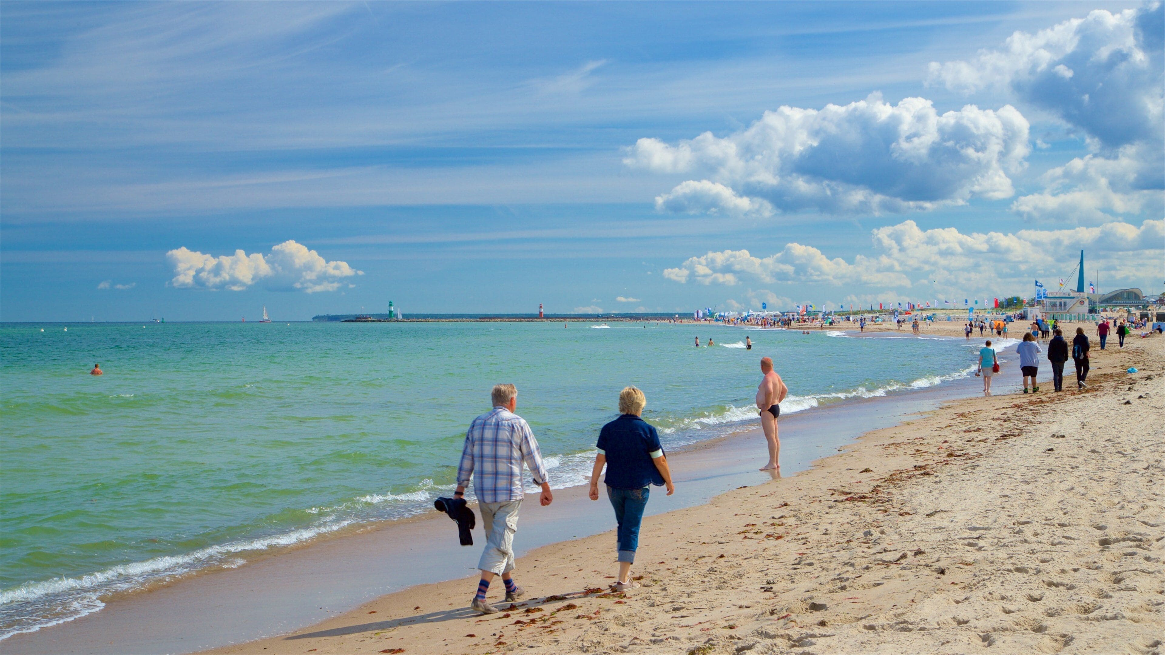 Warnemunde Beach which includes general coastal views and a sandy beach as well as a couple