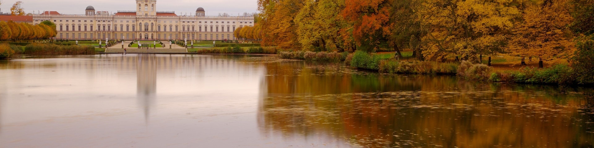 Reflection of Schloss Charlottenburg amidst autumn foliage in Berlin's Brandenburg Region