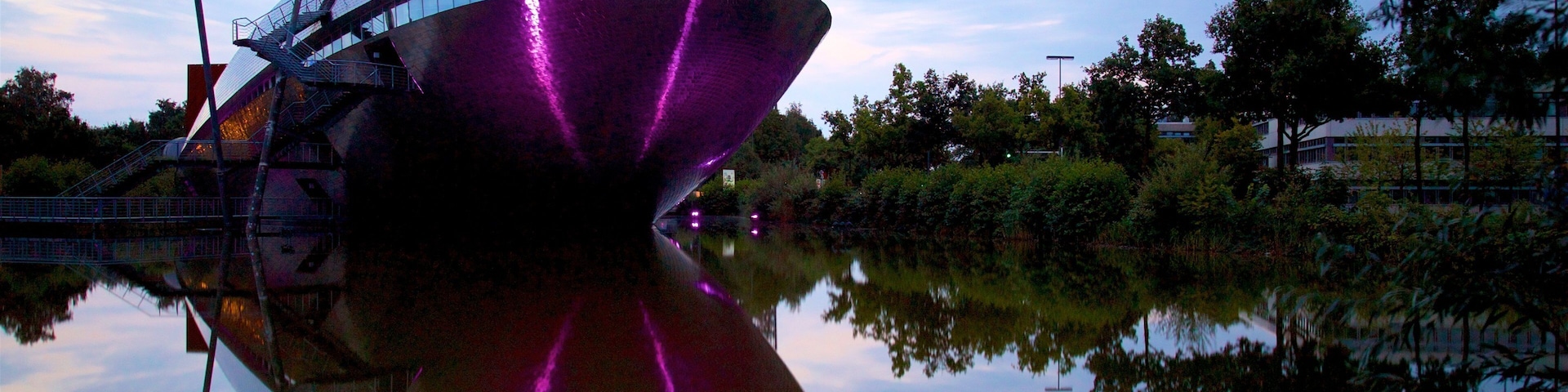 Universum Science Center featuring modern architecture and a lake or waterhole