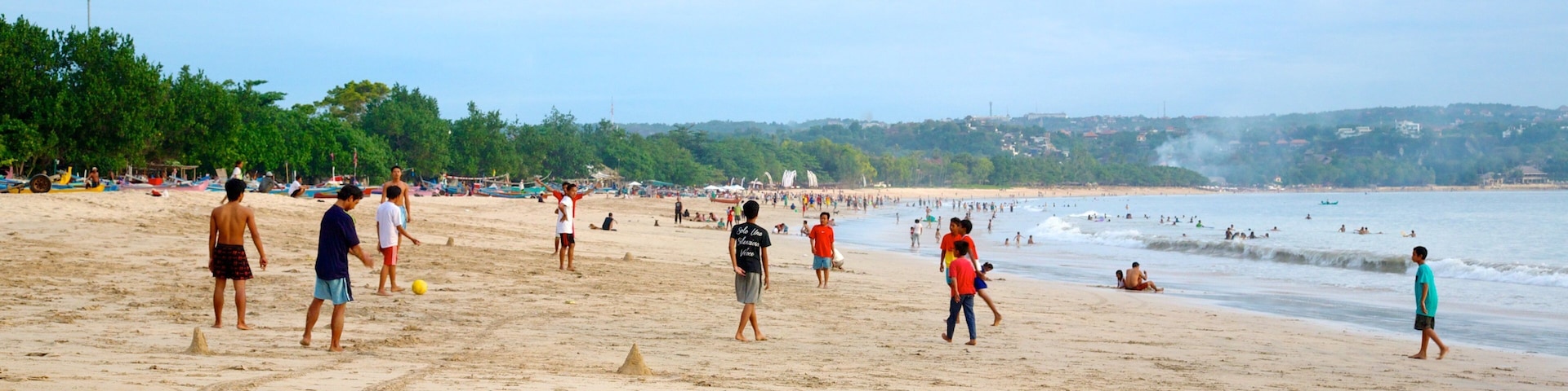 Jimbaran Beach featuring a beach as well as a large group of people