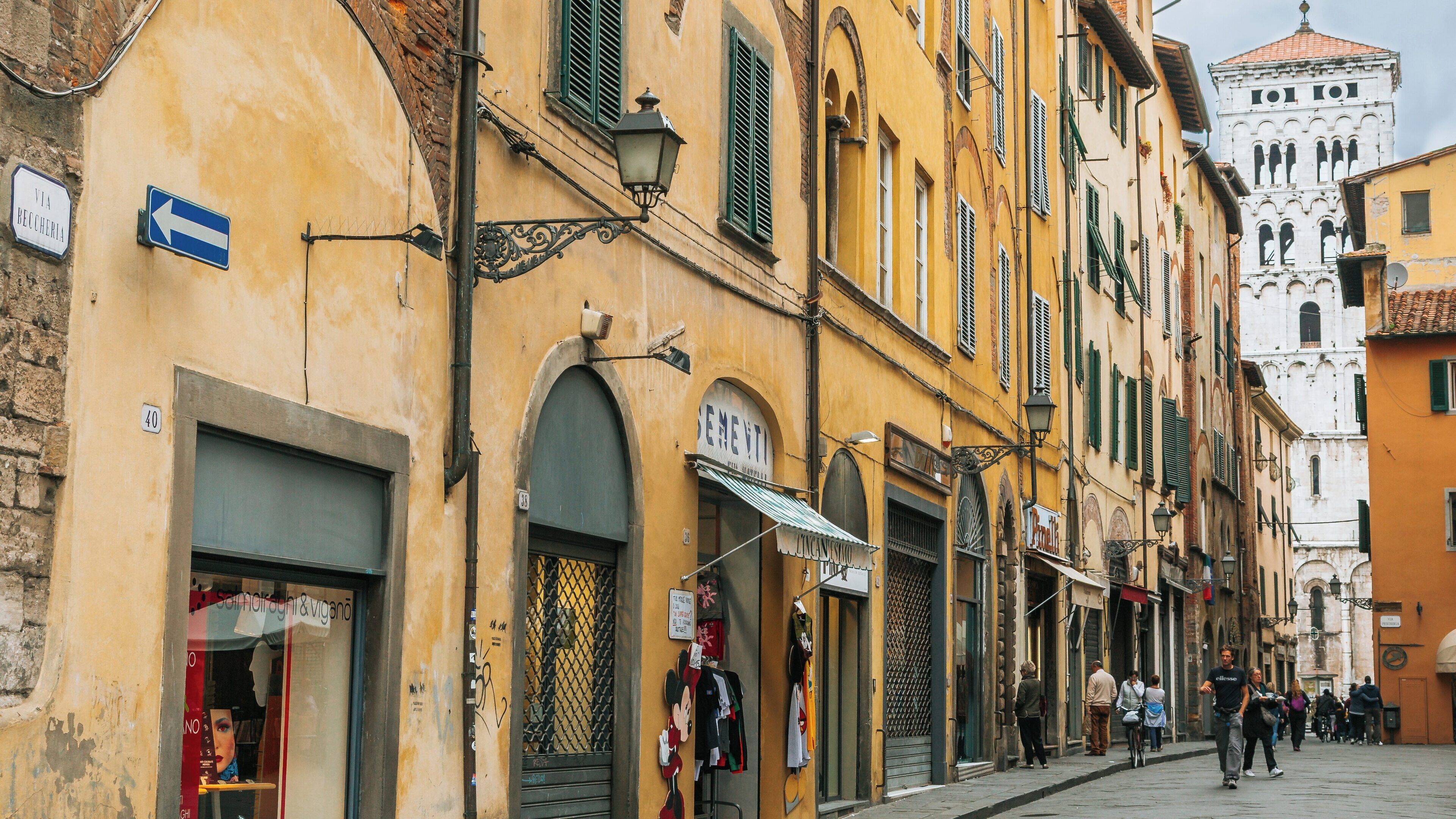Exploring the vibrant streets of Piazza Napoleone in Lucca, Tuscany, showcasing charming architecture and local life