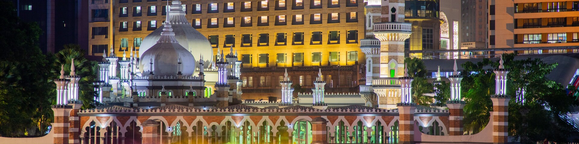 Jamek Mosque showing mist or fog, heritage architecture and a city