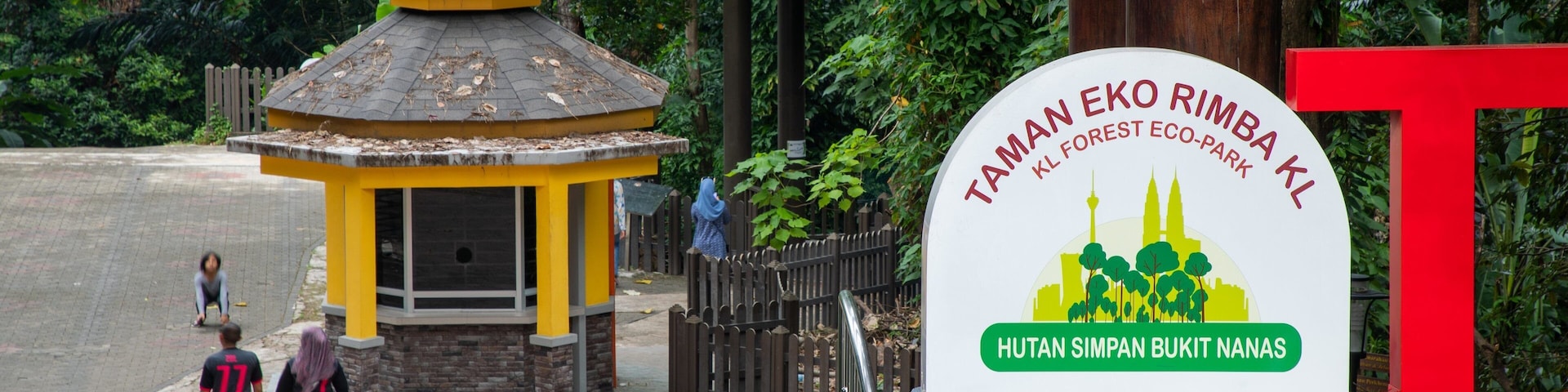Bukit Nanas Forest Reserve featuring street scenes and signage as well as a couple