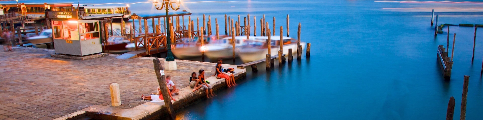 Small Islands of Venice which includes a bay or harbor and night scenes as well as a small group of people