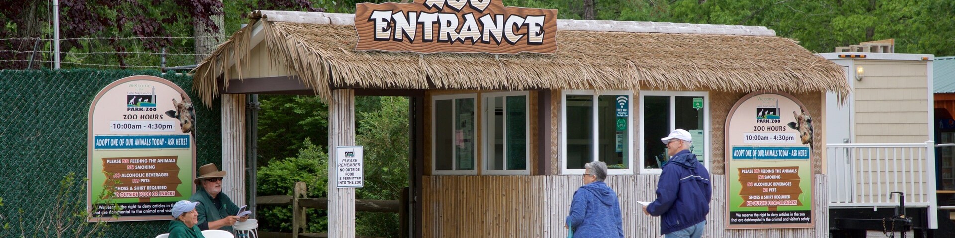 Cape May County Zoo showing signage as well as a couple