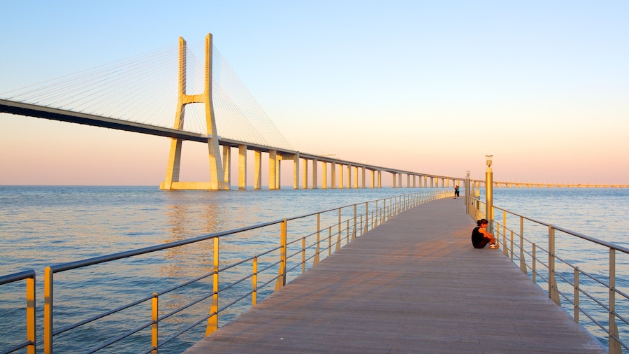Vasco da Gama Bridge which includes a bridge, a sunset and a bay or harbor
