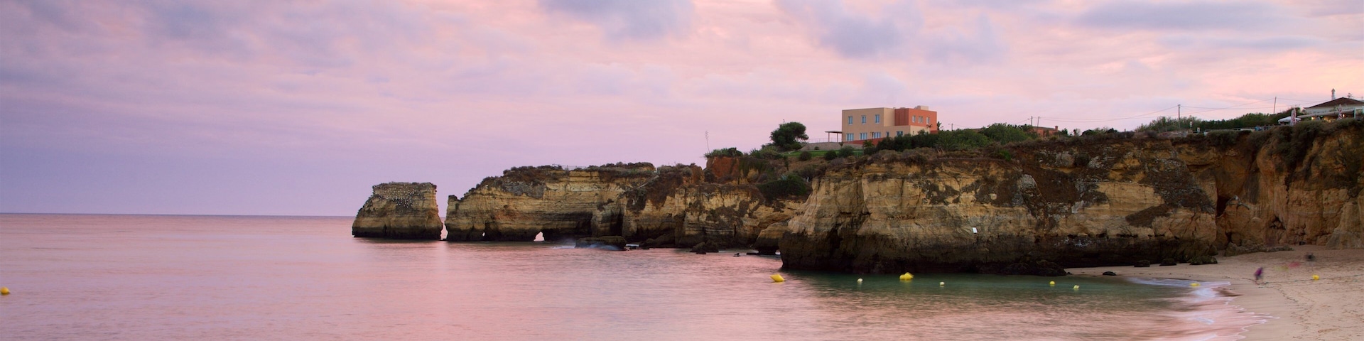 Batata Beach which includes rugged coastline, a sunset and general coastal views