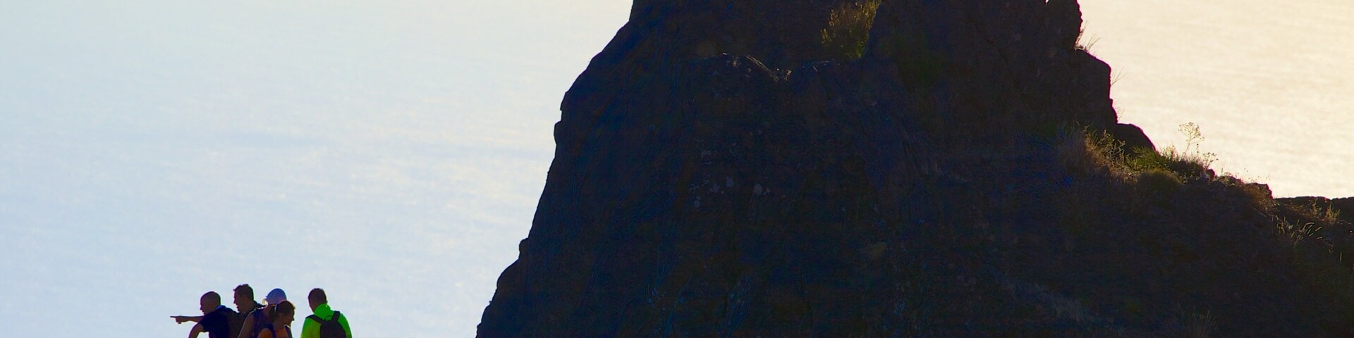 Pico do Ariero showing mountains and views as well as a small group of people