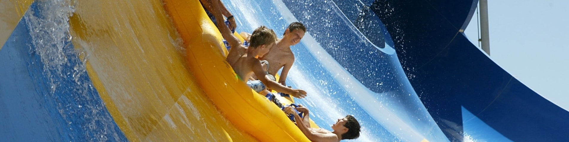 Six Flags Hurricane Harbor featuring a waterpark as well as a small group of people