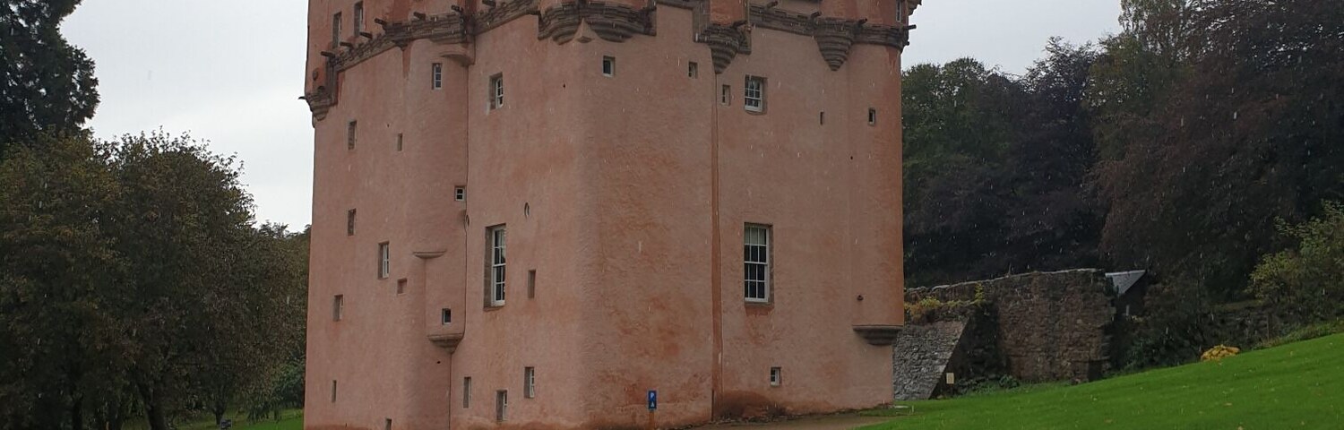 The castle with the first of the golden autumn leaves on the ground
