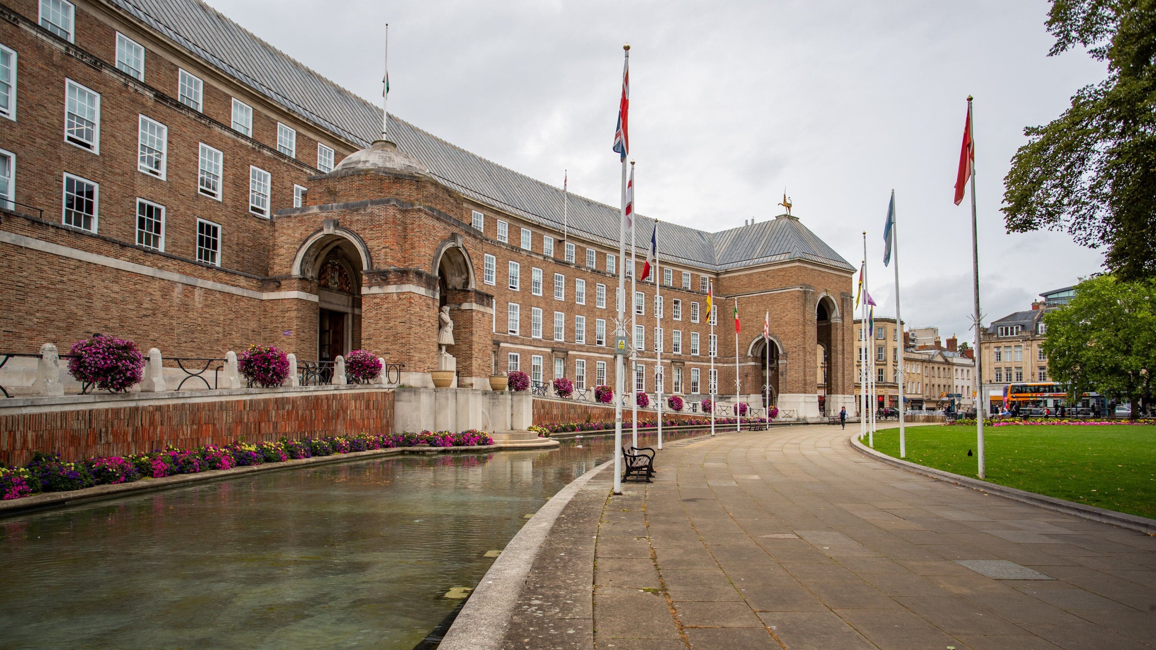 Bristol City Hall showing flowers, heritage architecture and a river or creek