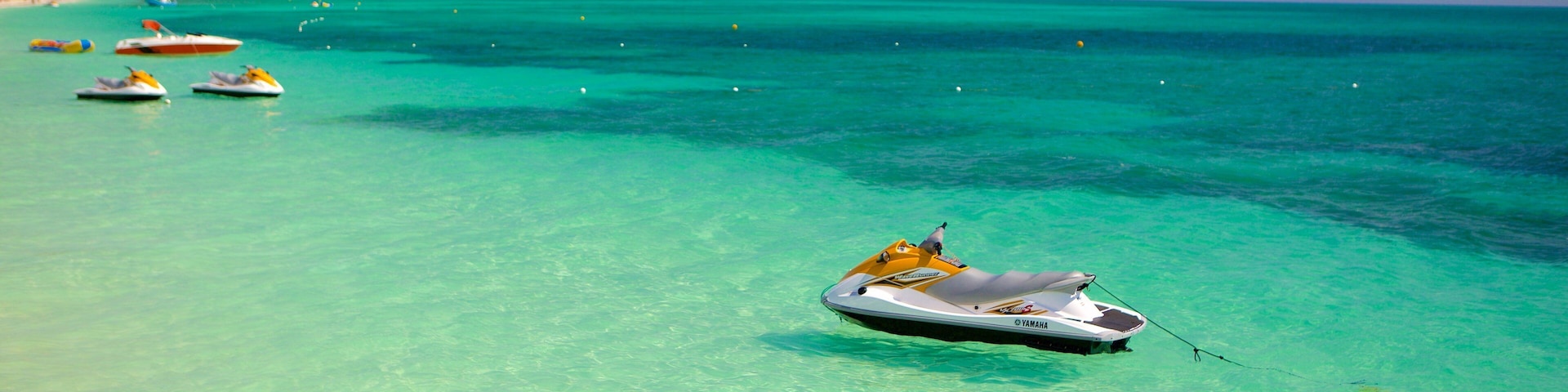 Taino Beach showing jet skiing and general coastal views