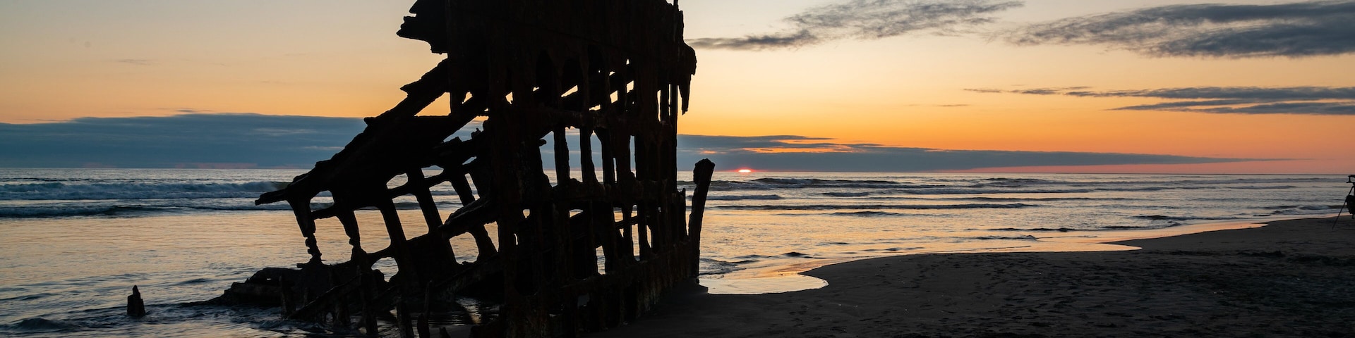 Fort Stevens State Park featuring general coastal views, a sunset and building ruins