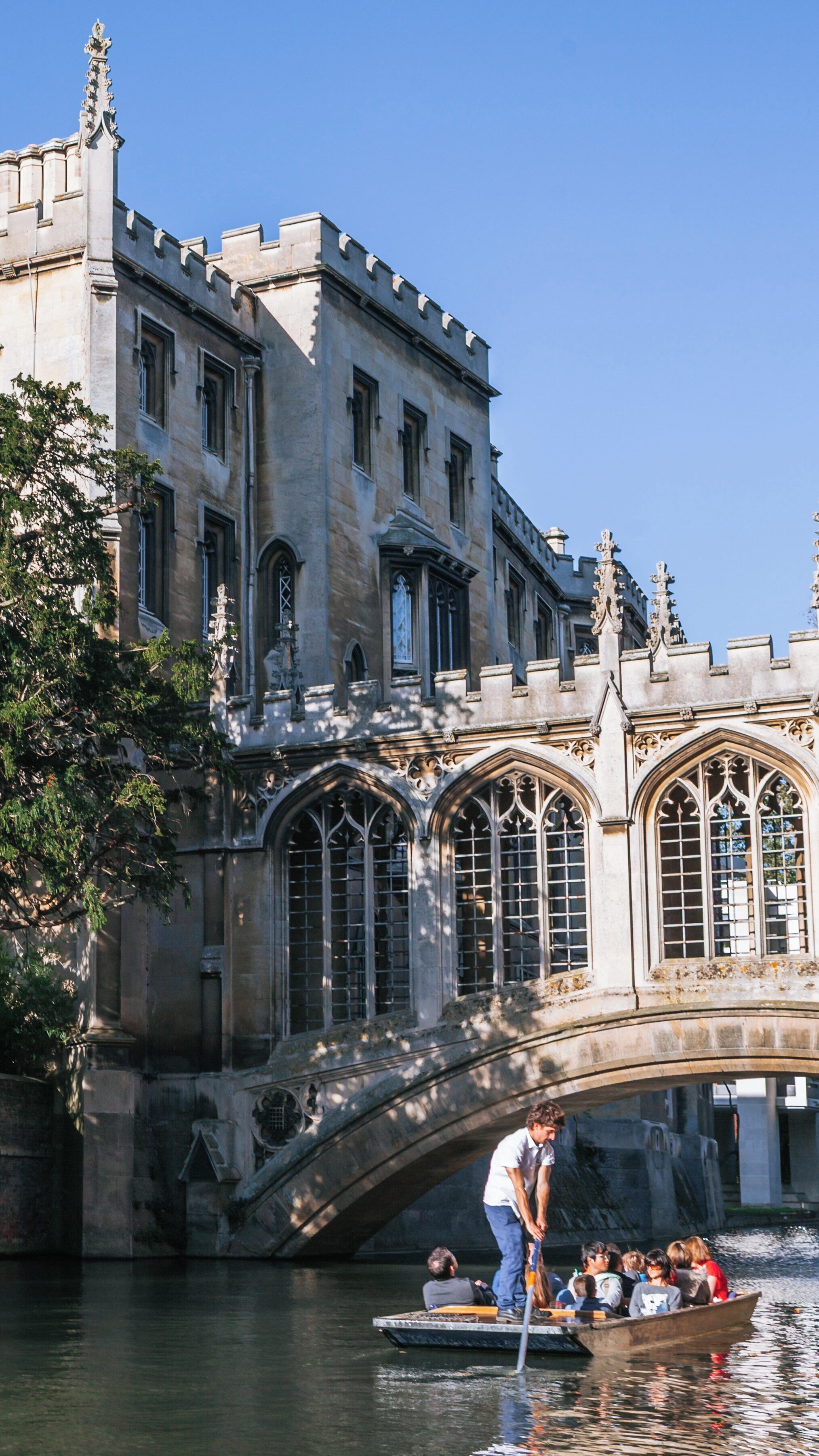 Scenic view of the Bridge of Sighs in Cambridge with visitors enjoying a punt on the River Cam