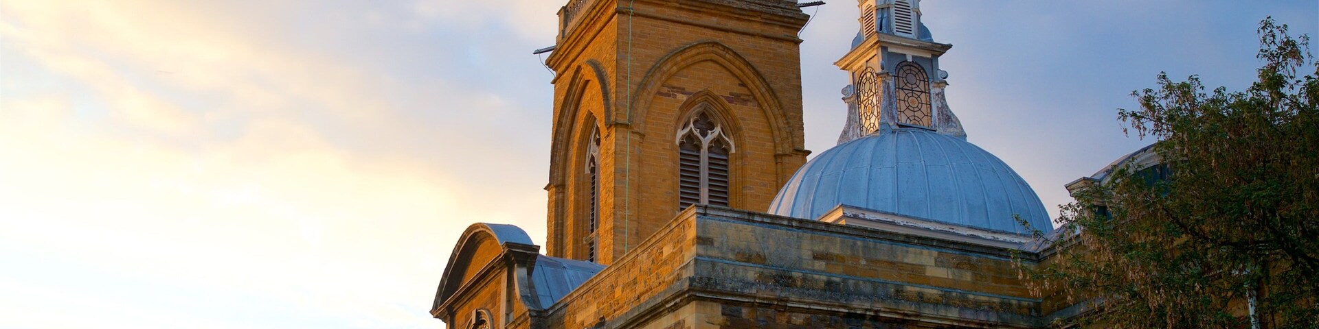 All Saints Church que inclui arquitetura de patrimônio, uma igreja ou catedral e um pôr do sol