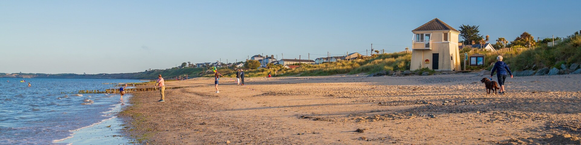 Rosslare Beach which includes general coastal views, a beach and a sunset