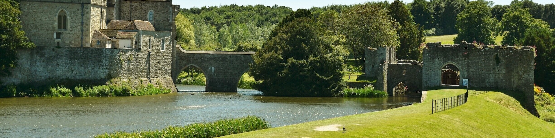 Leeds Castle is in Kent, England, 5 miles (8 km) southeast of Maidstone. A castle has been on the site since 1119. In the 13th century it came into the hands of King Edward I, for whom it became a favourite residence; in the 16th century, Henry VIII used it as a dwelling for his first wife, Catherine of Aragon. The castle today dates mostly from the 19th century and is built on islands in a lake formed by the River Len to the east of the village of Leeds. It has been open to the public since 1976