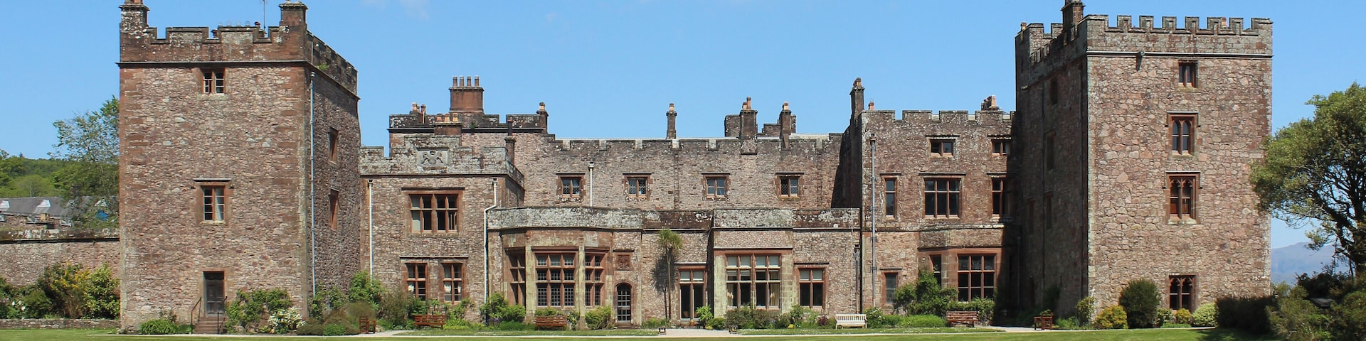 Muncaster Castle viewed from the south-west. The oldest parts of the castle are believed to have been built in the 14th century, possibly on the site of a Roman fort. It was extensively refurbished during the Victorian era.