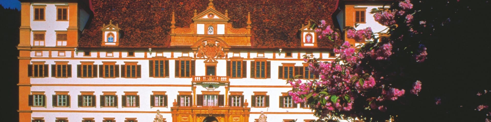 Eggenberg Palace which includes a square or plaza, flowers and chateau or palace