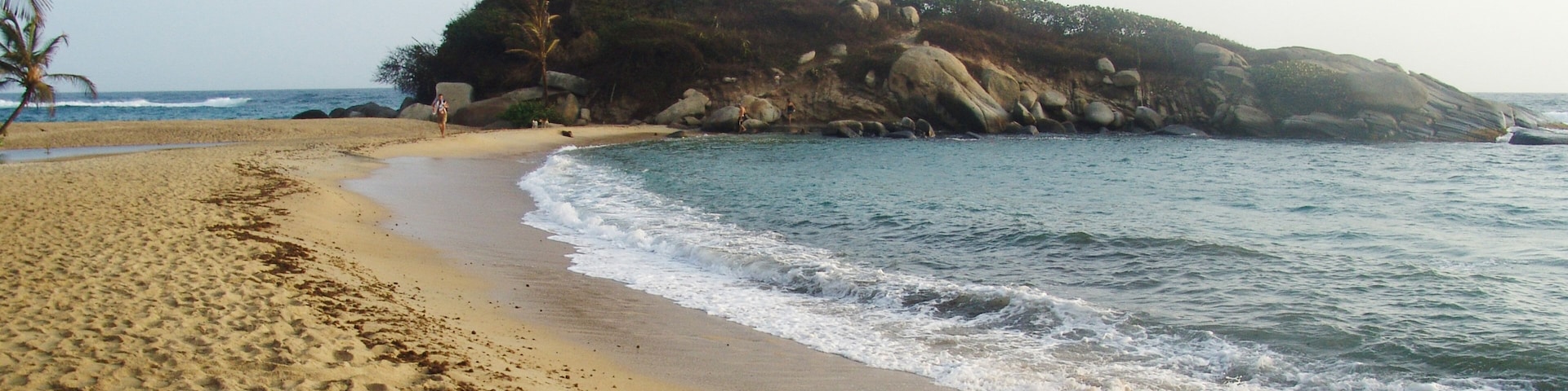 Tayrona National Natural Park showing a beach, general coastal views and a sunset