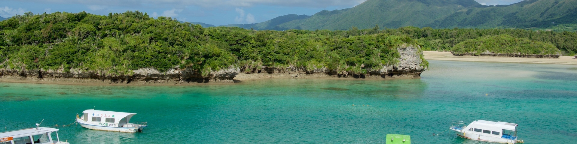 Kabira Bay Beach showing boating and a sandy beach