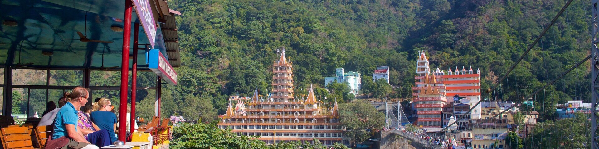 Lakshman Jhula which includes a suspension bridge or treetop walkway, a river or creek and a small town or village