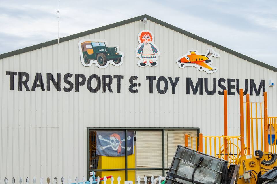 A building with a sign reading "Transport & Toy Museum".
