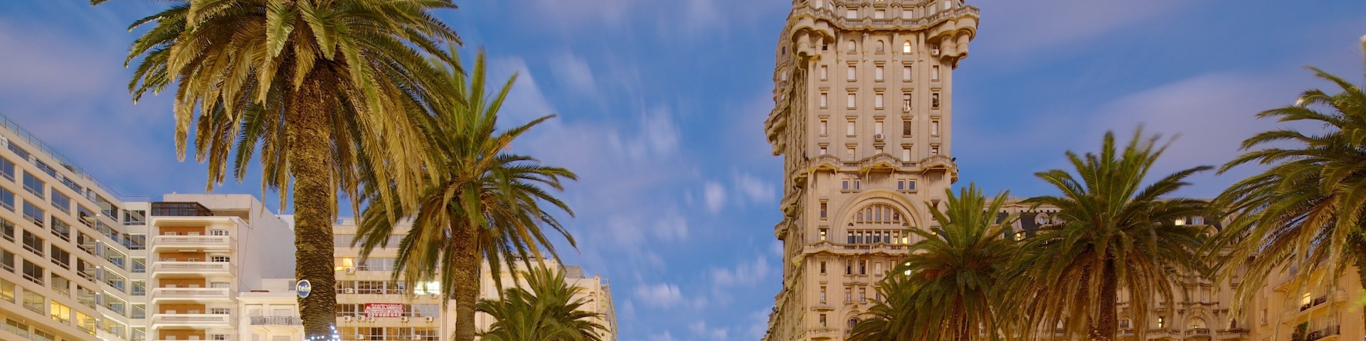 Salvo Palace showing a city, street scenes and a sunset