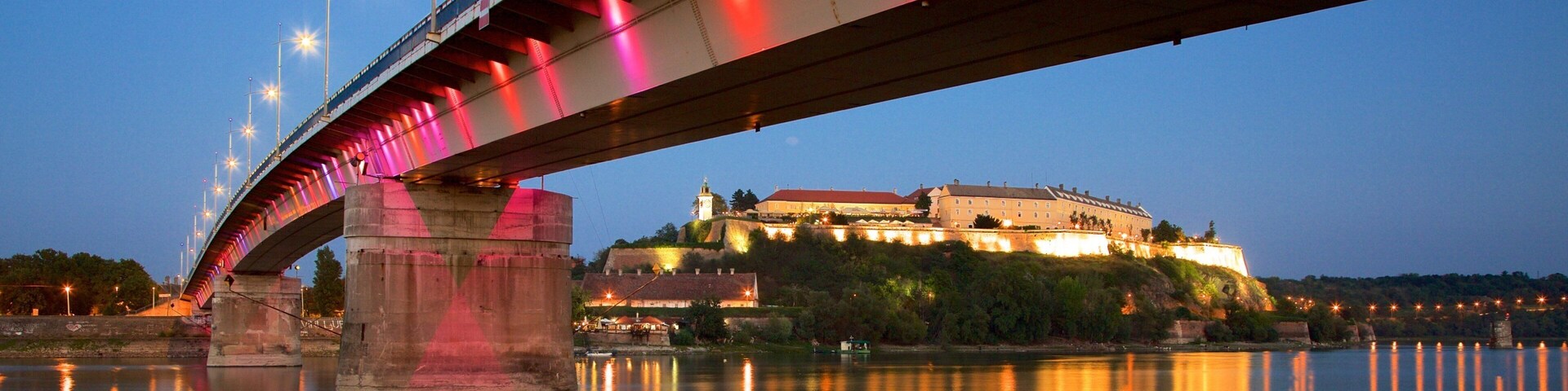 Petrovaradin Fortress showing a river or creek, a bridge and night scenes