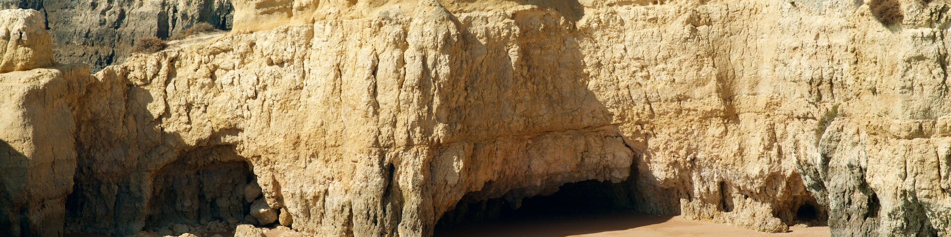 Coelha Beach showing a sandy beach, rugged coastline and general coastal views