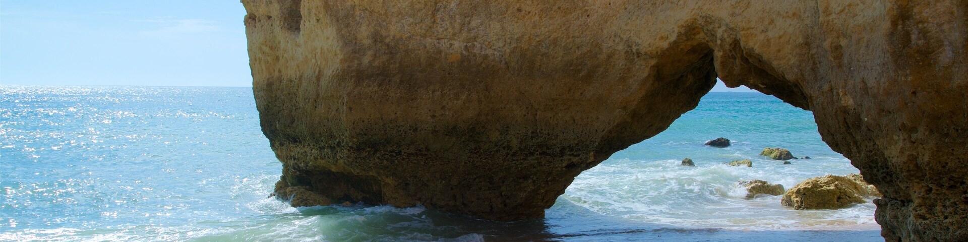 Coelha Beach showing rugged coastline, general coastal views and a beach